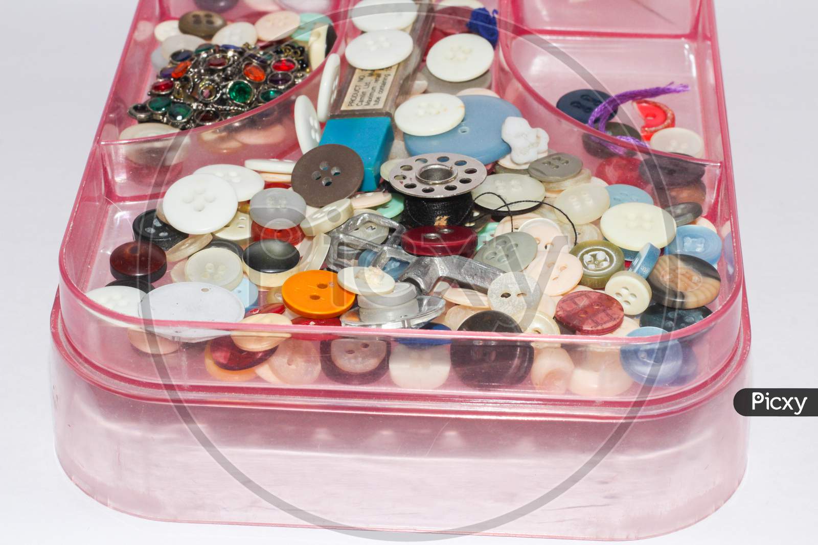 Image of semi transparent pink box with threads on white background ...