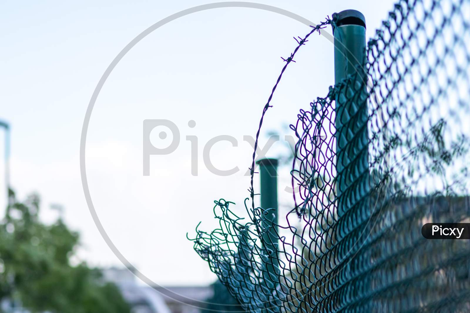 Image of Green damaged wire-mesh fence is ruined after collision with ...