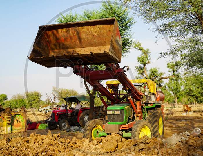 Image of Loader Tractor Rides On Agriculture Field To Carry Out Loading ...