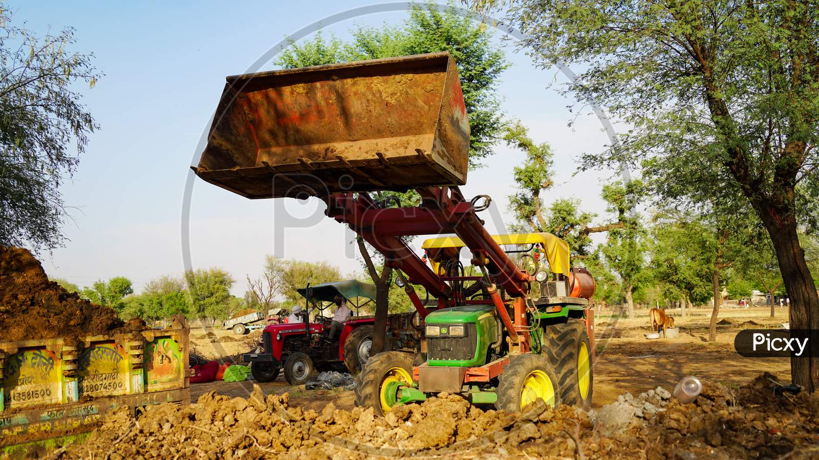 Image of Loader Tractor Rides On Agriculture Field To Carry Out Loading ...