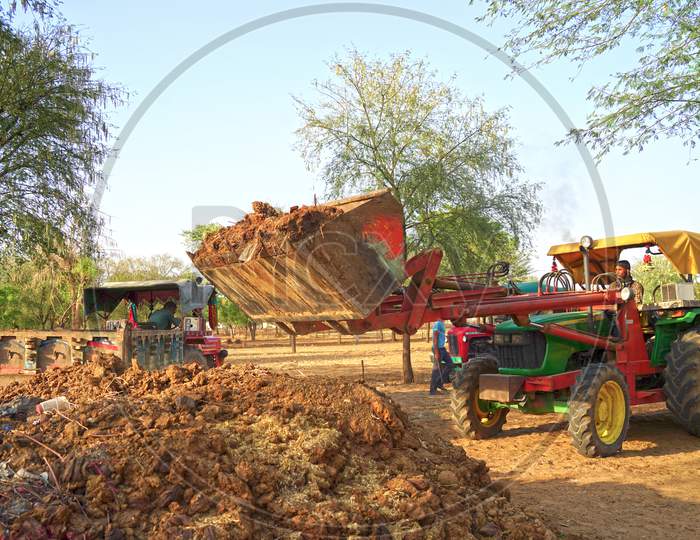 Image of Loader Tractor Rides On Agriculture Field To Carry Out Loading ...