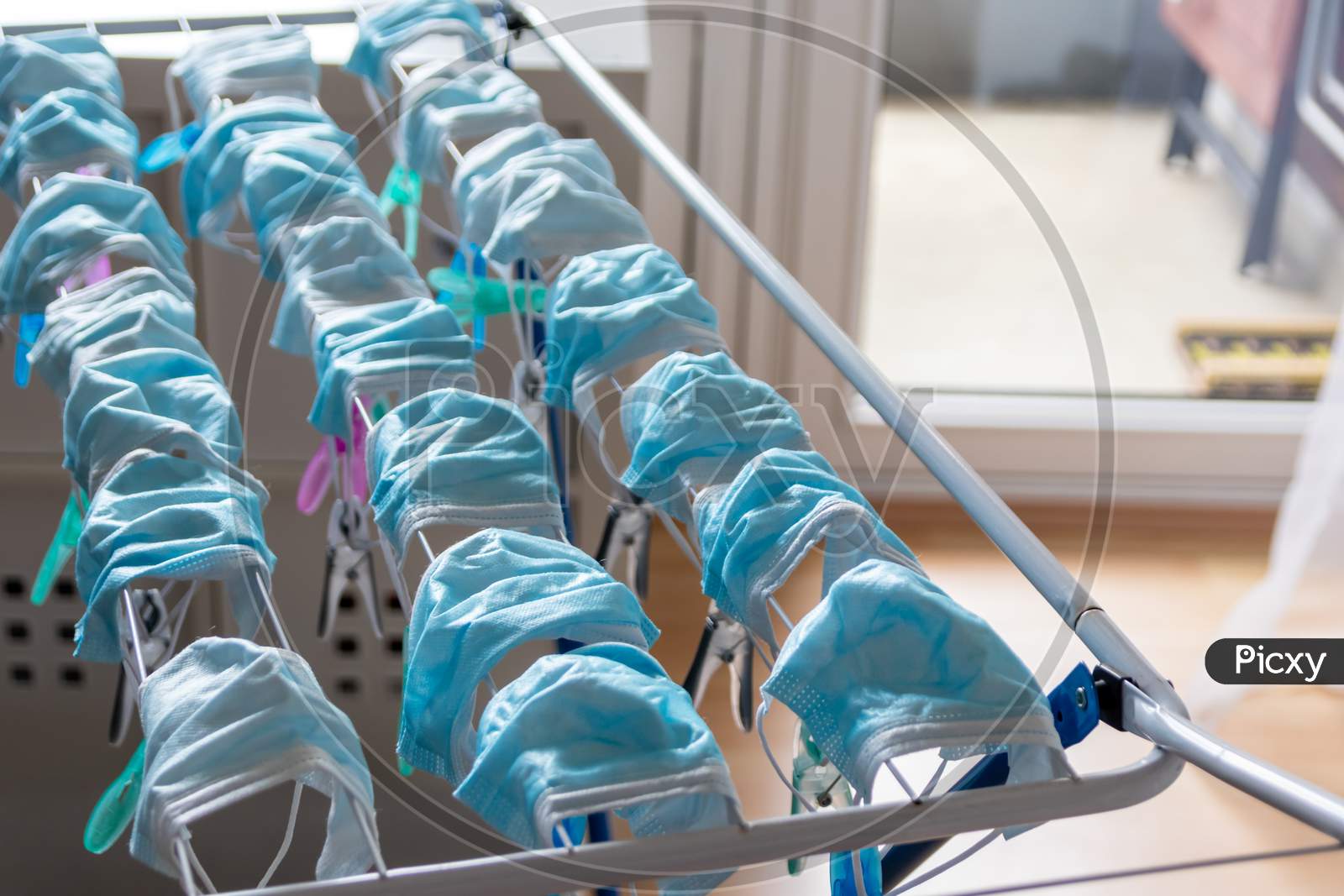 Image of Washed surgical masks hanging on a clothes drying rack after ...
