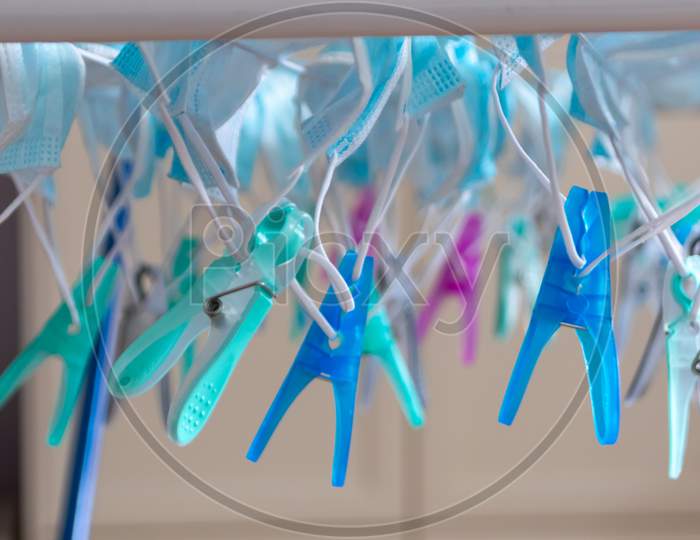 Image of Washed surgical masks hanging on a clothes drying rack after ...
