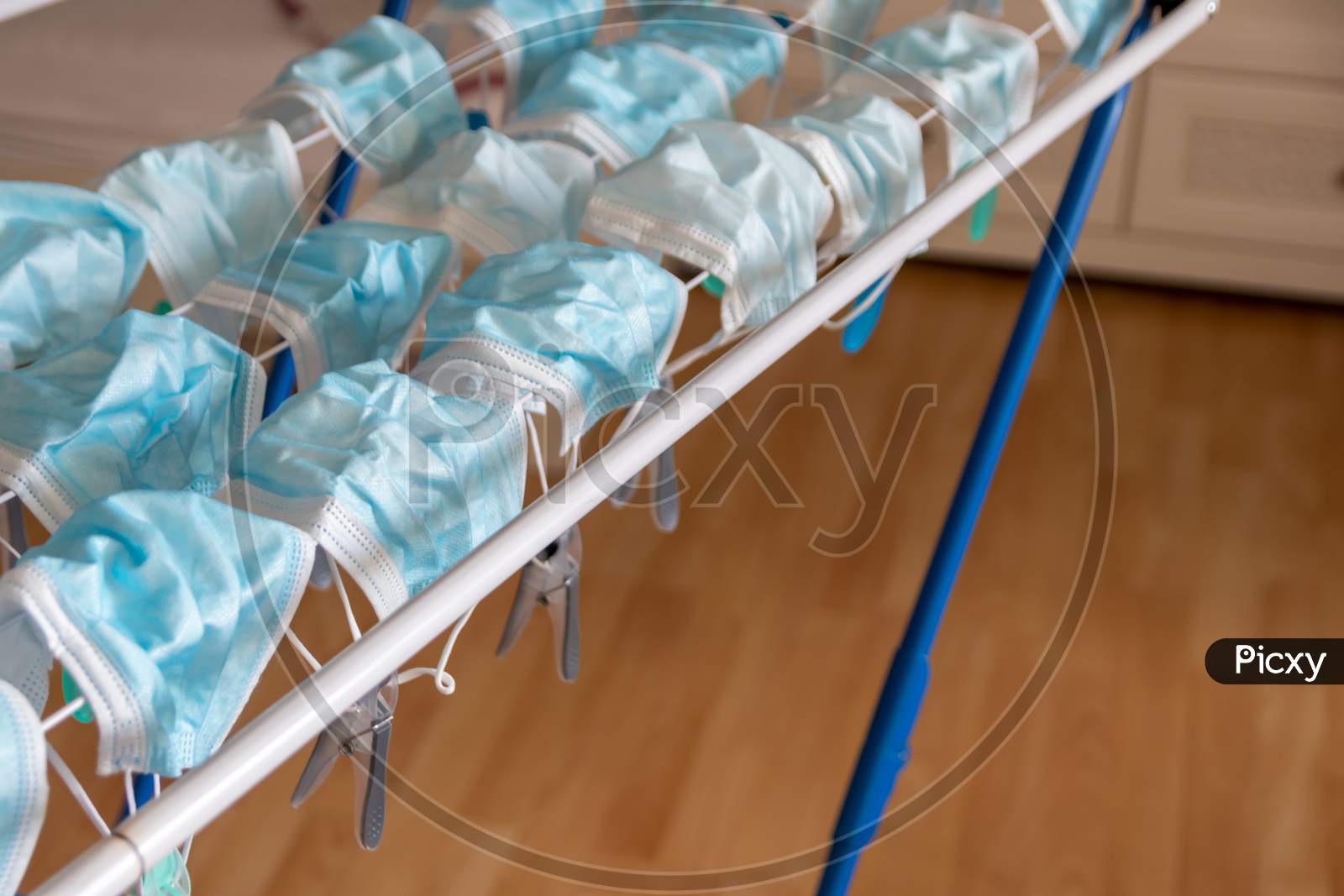 Image of Washed surgical masks hanging on a clothes drying rack after ...