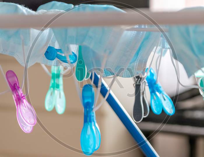 Image of Washed surgical masks hanging on a clothes drying rack after ...