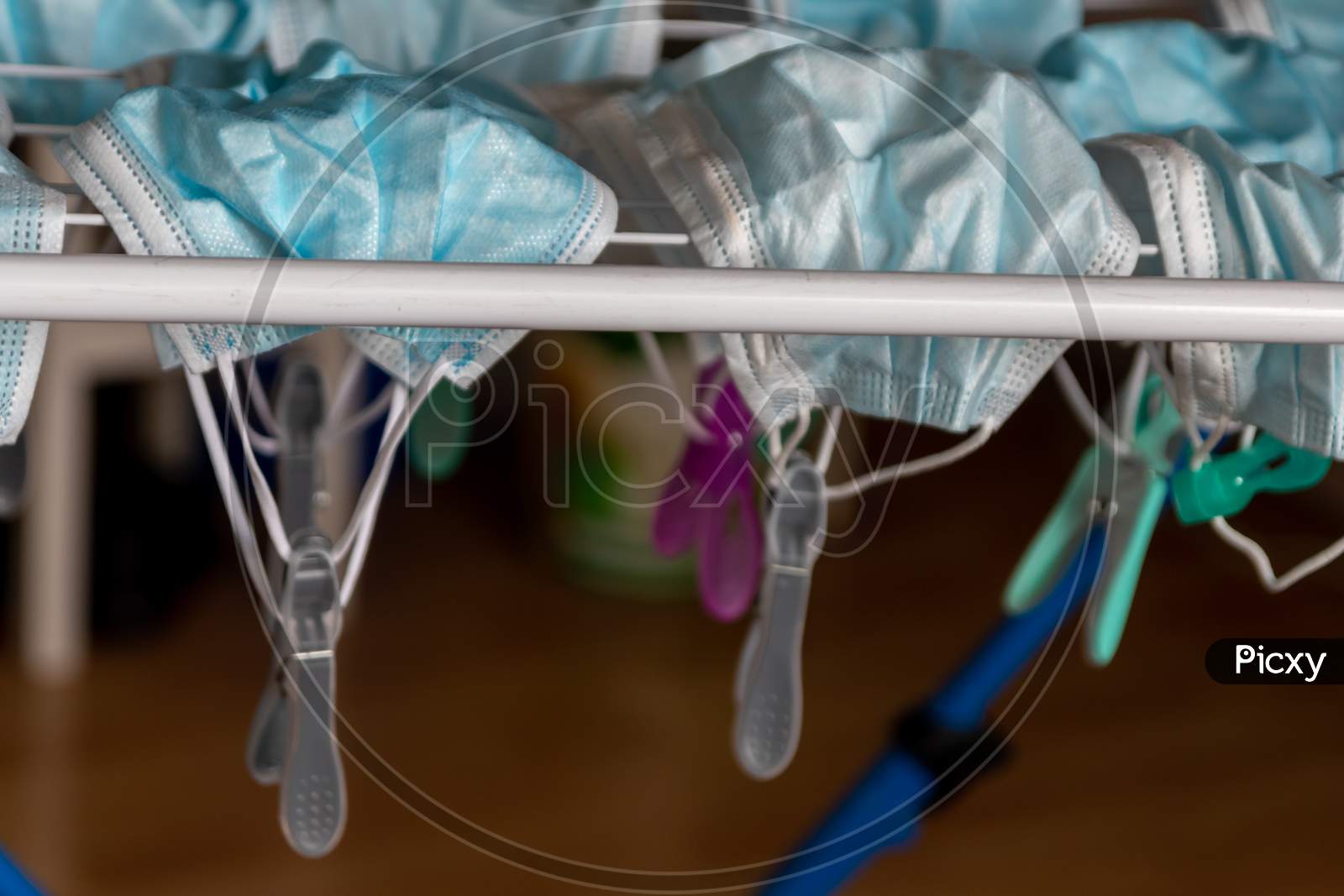 Image of Washed surgical masks hanging on a clothes drying rack after ...