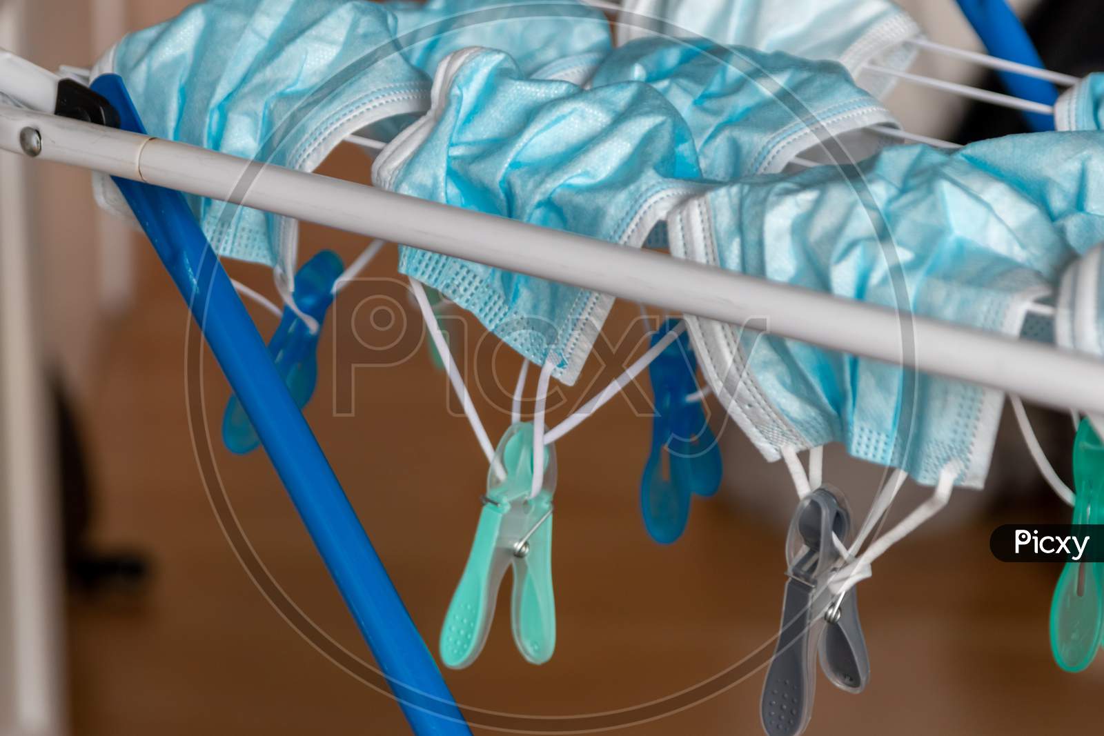 Image of Washed surgical masks hanging on a clothes drying rack after ...