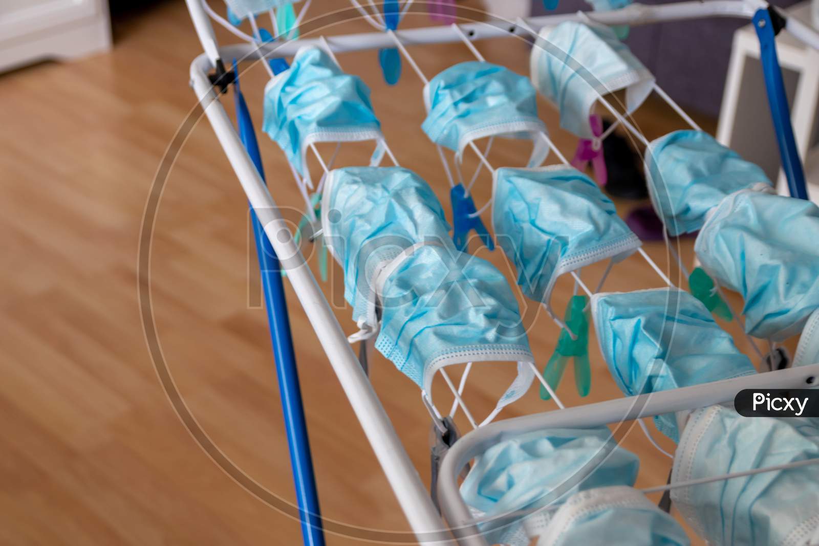 Image of Washed surgical masks hanging on a clothes drying rack after ...