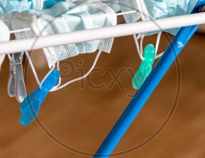 Image of Washed surgical masks hanging on a clothes drying rack after ...