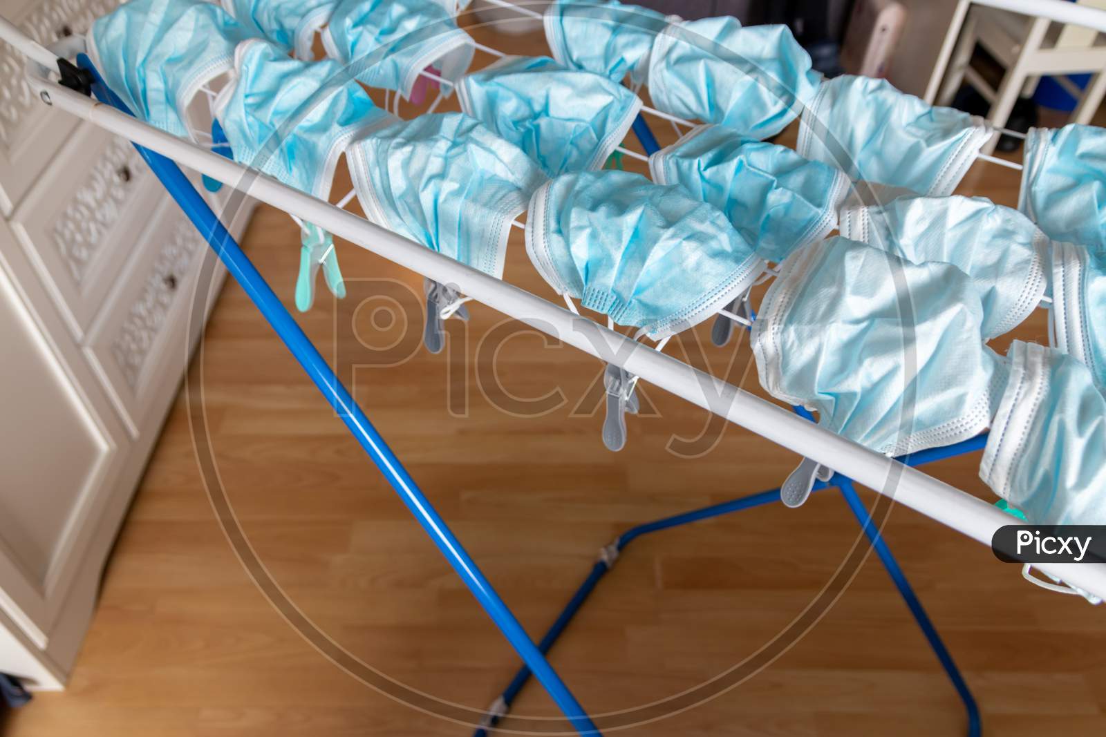 Image of Washed surgical masks hanging on a clothes drying rack after ...