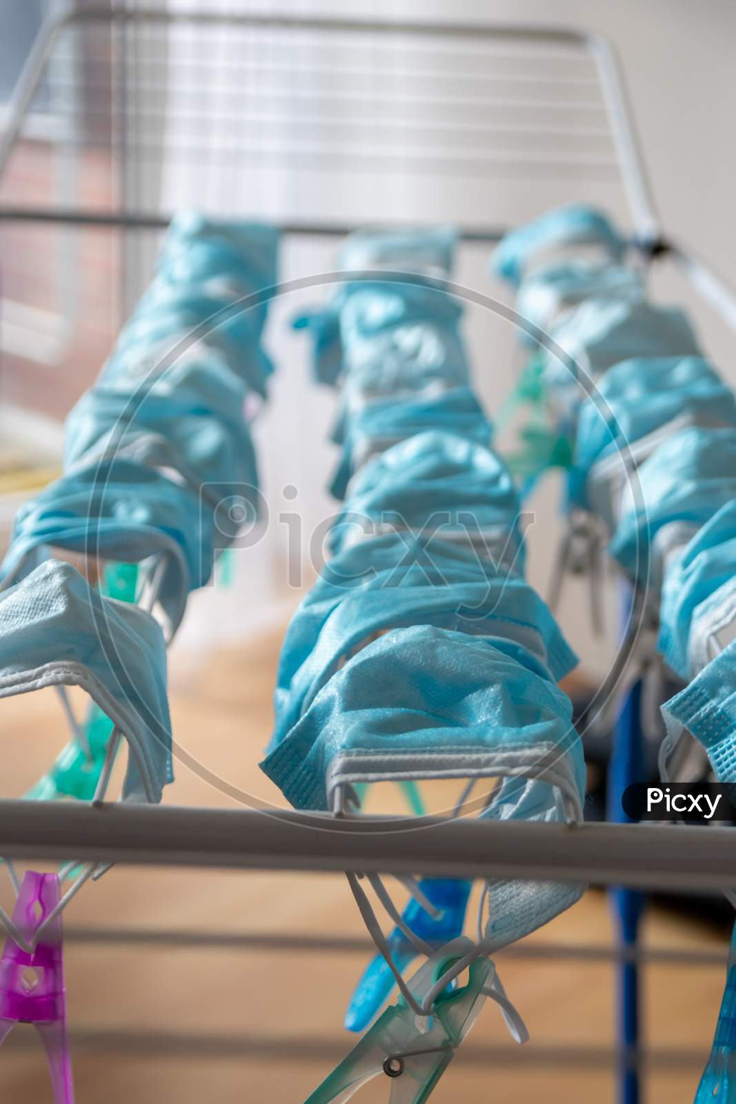 Image of Washed surgical masks hanging on a clothes drying rack after ...
