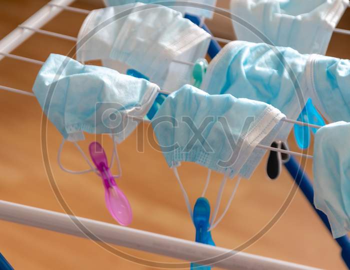 Image of Washed surgical masks hanging on a clothes drying rack after ...