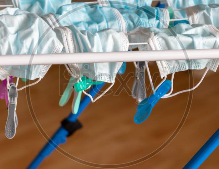 Image of Washed surgical masks hanging on a clothes drying rack after ...