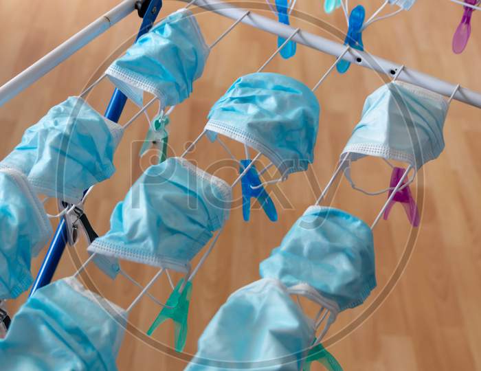 Image of Washed surgical masks hanging on a clothes drying rack after ...