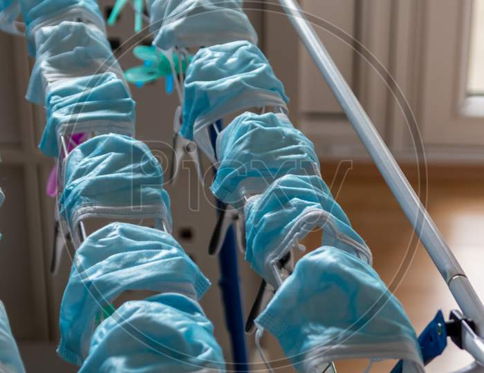 Image of Washed surgical masks hanging on a clothes drying rack after ...