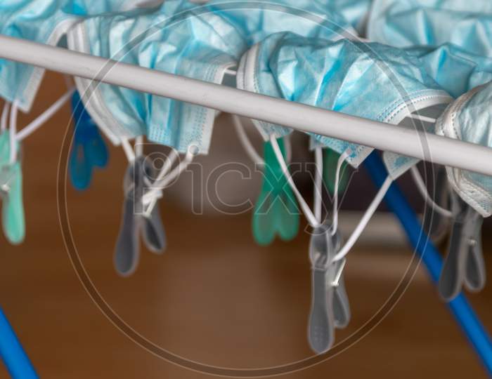Image of Washed surgical masks hanging on a clothes drying rack after ...