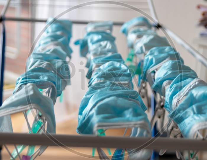Image of Washed surgical masks hanging on a clothes drying rack after ...