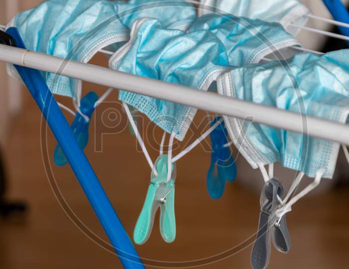 Image of Washed surgical masks hanging on a clothes drying rack after ...