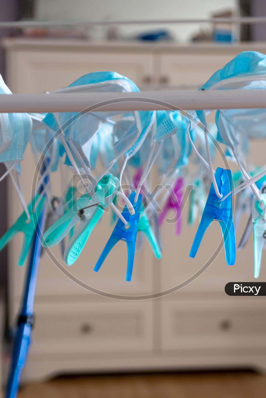 Image of Washed surgical masks hanging on a clothes drying rack after ...