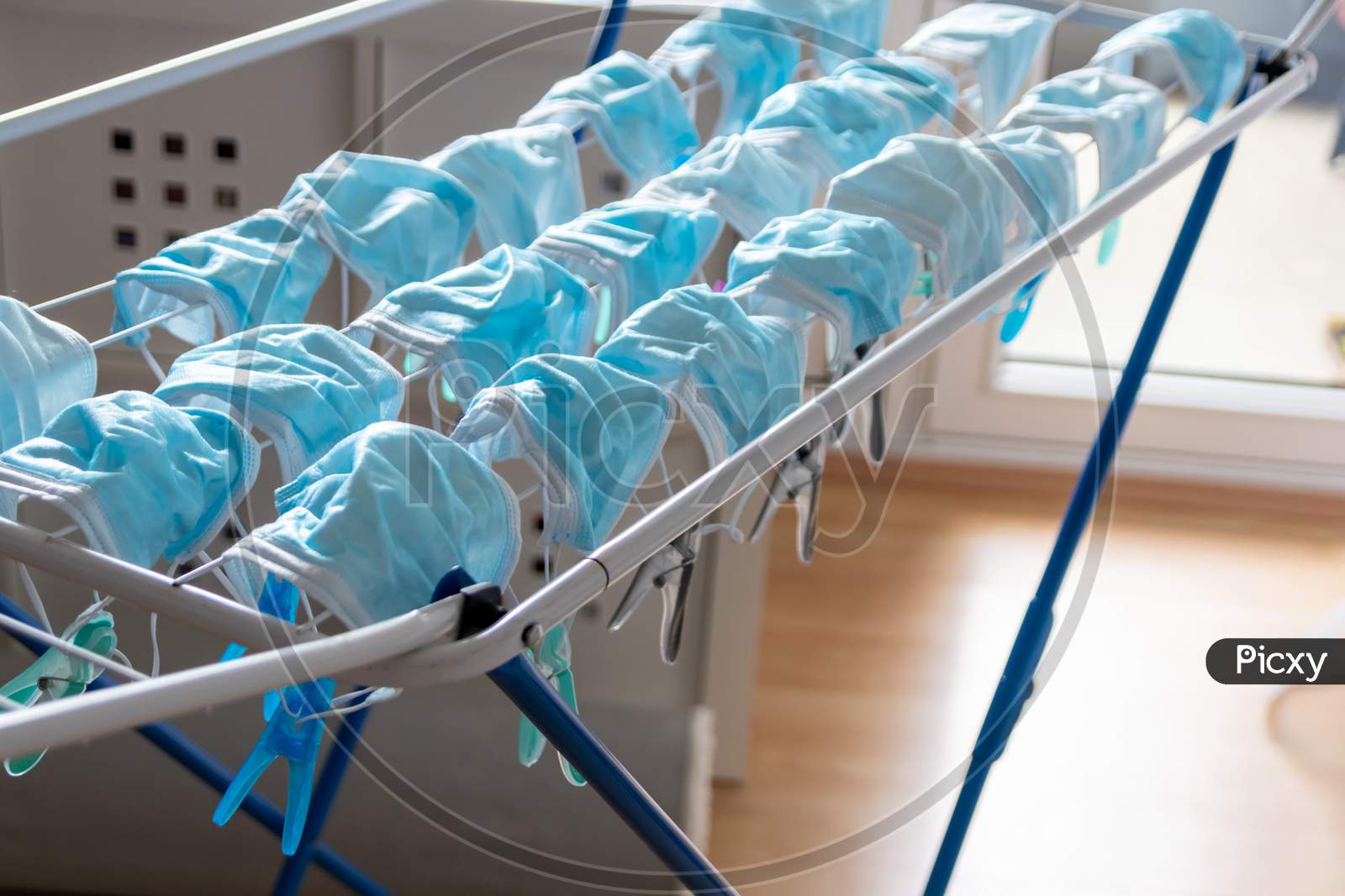 Image of Washed surgical masks hanging on a clothes drying rack after ...