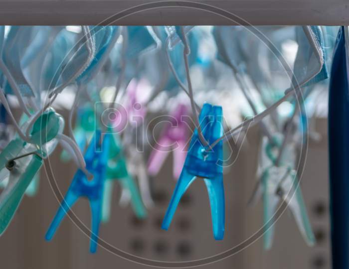 Image of Washed surgical masks hanging on a clothes drying rack after ...