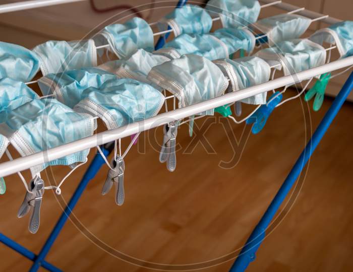 Image of Washed surgical masks hanging on a clothes drying rack after ...