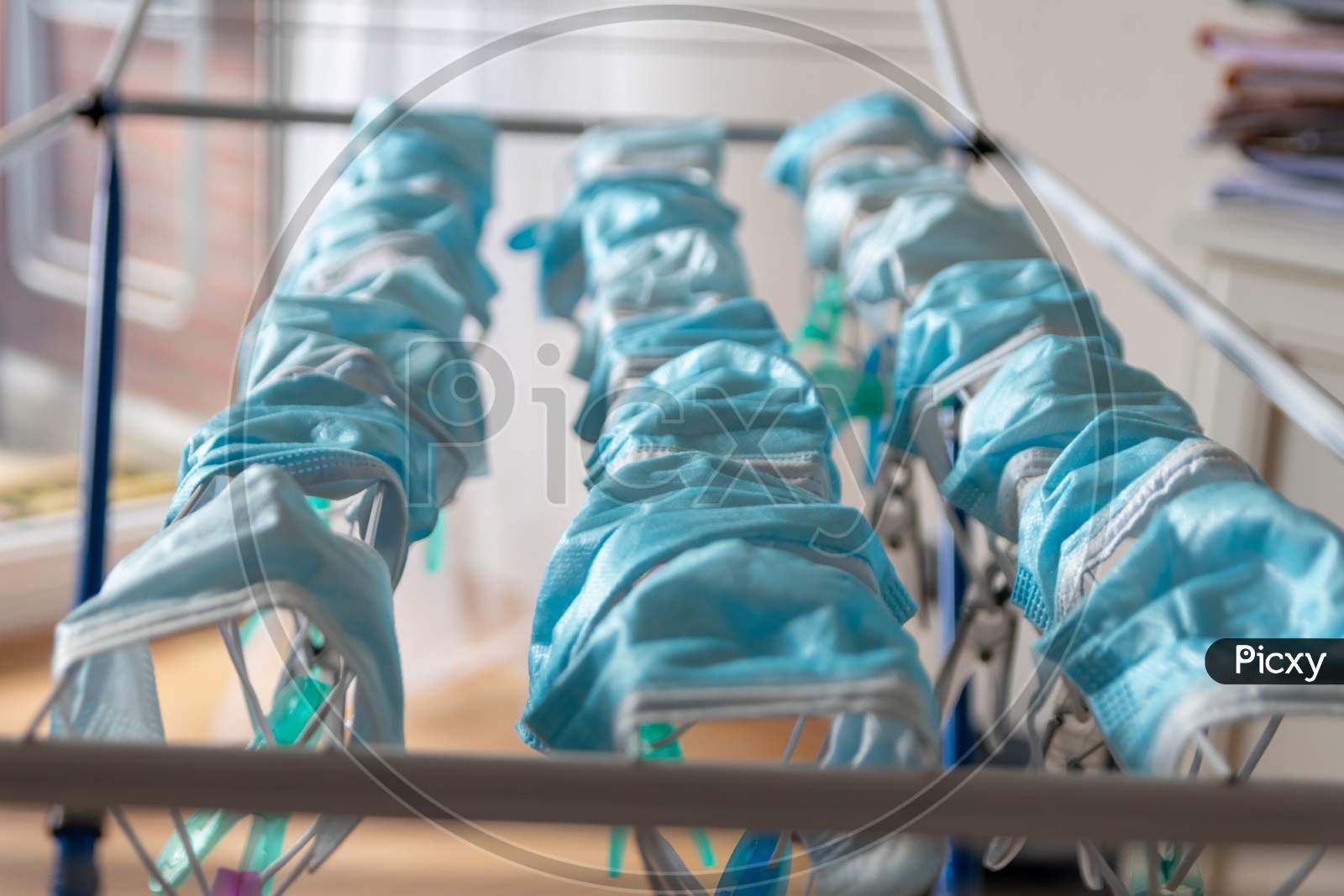 Image of Washed surgical masks hanging on a clothes drying rack after ...