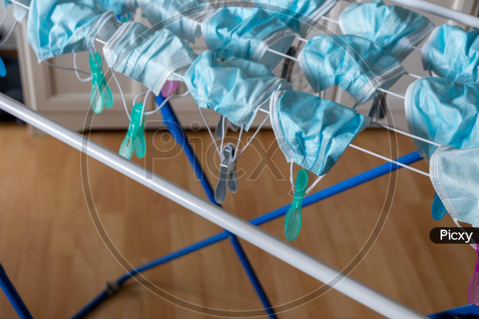 Image of Washed surgical masks hanging on a clothes drying rack after ...