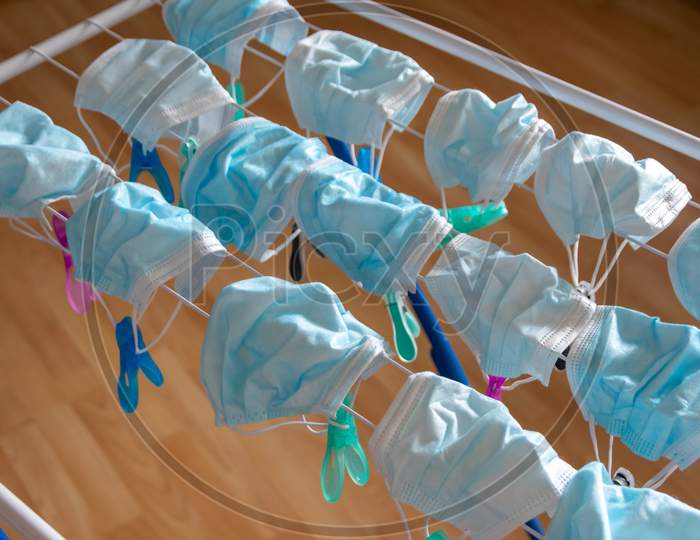 Image of Washed surgical masks hanging on a clothes drying rack after ...