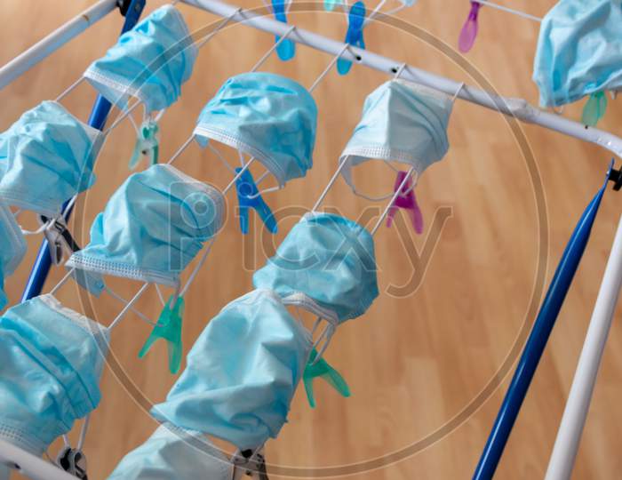 Image of Washed surgical masks hanging on a clothes drying rack after ...