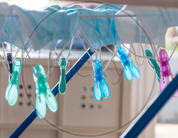 Image of Washed surgical masks hanging on a clothes drying rack after ...