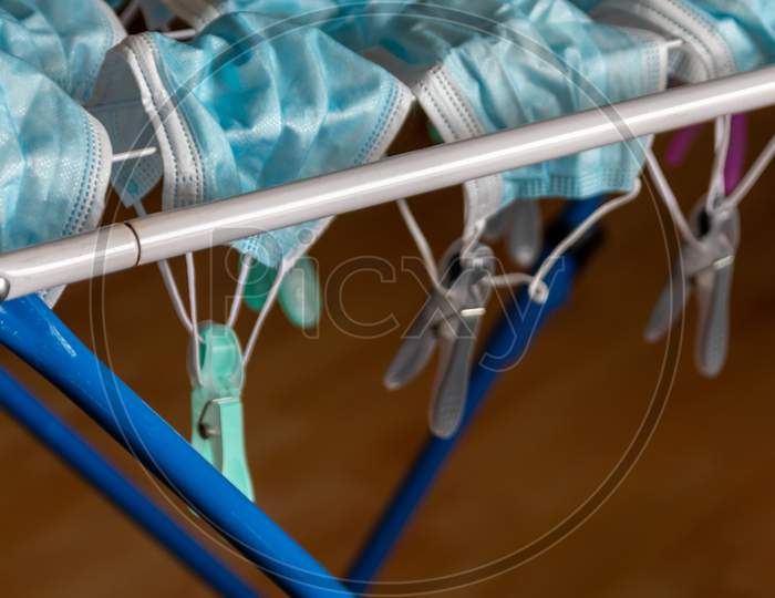 Image of Washed surgical masks hanging on a clothes drying rack after ...