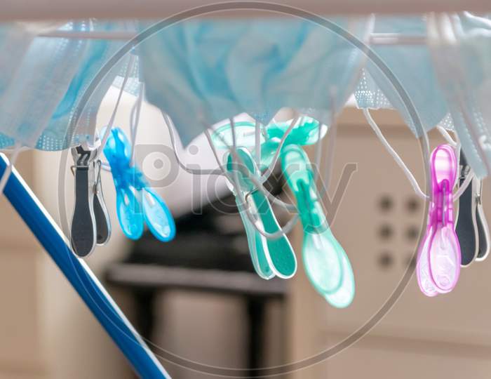 Image of Washed surgical masks hanging on a clothes drying rack after ...