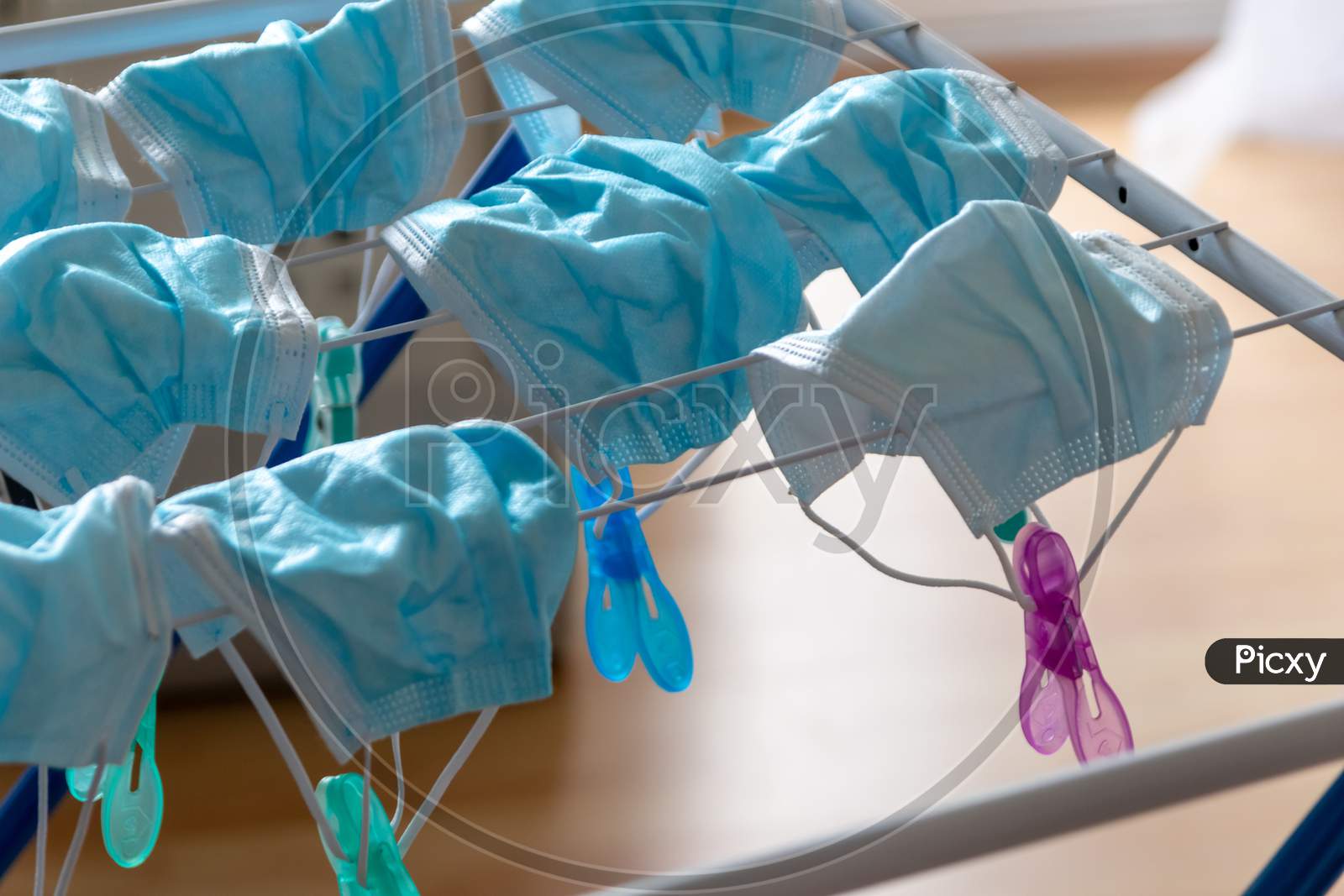 Image of Washed surgical masks hanging on a clothes drying rack after ...