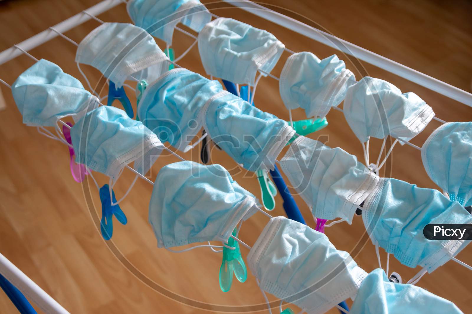 Image of Washed surgical masks hanging on a clothes drying rack after ...