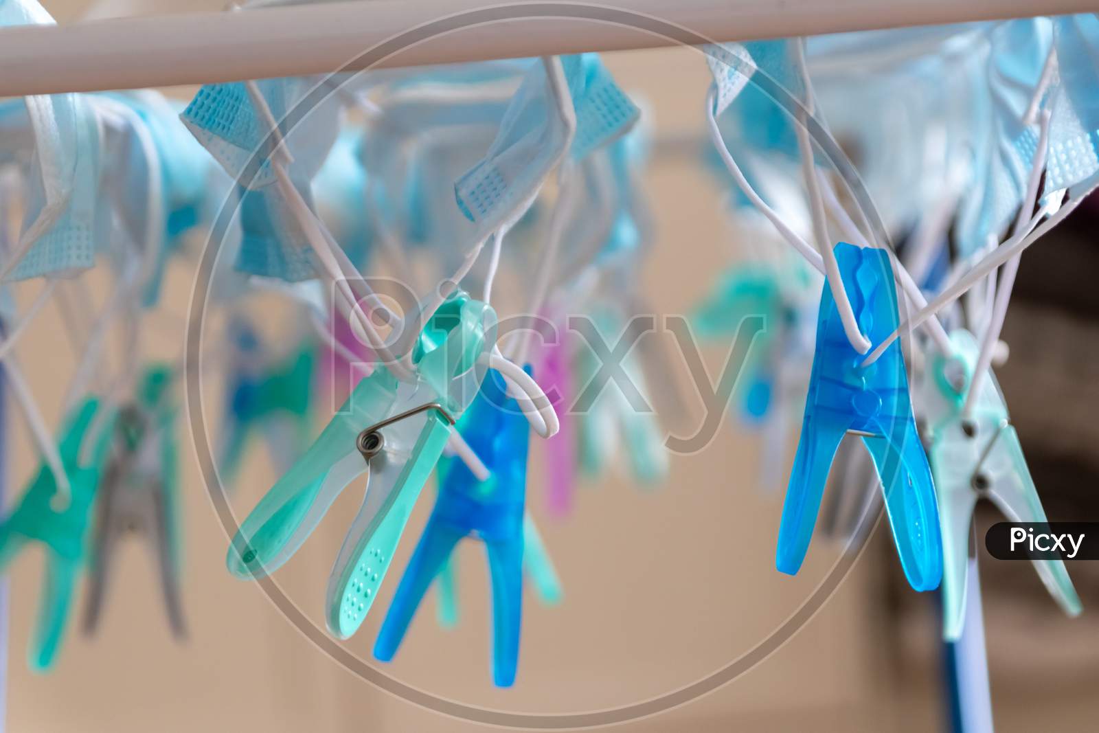 Image of Washed surgical masks hanging on a clothes drying rack after ...