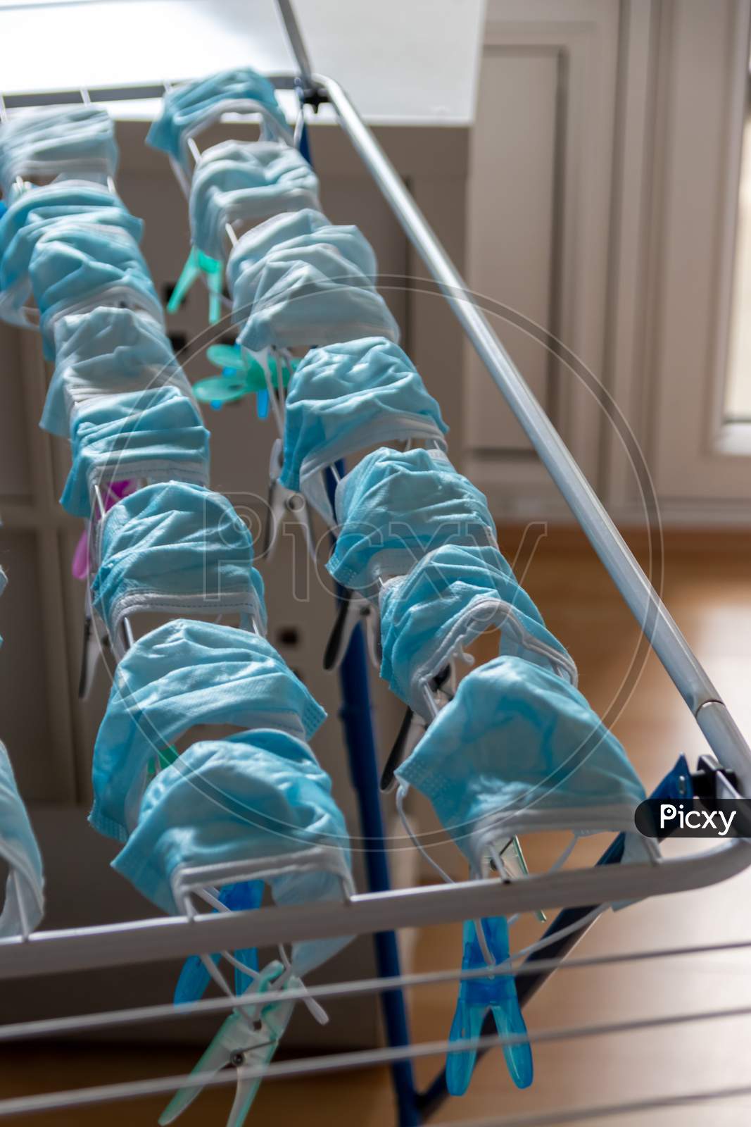 Image of Washed surgical masks hanging on a clothes drying rack after ...