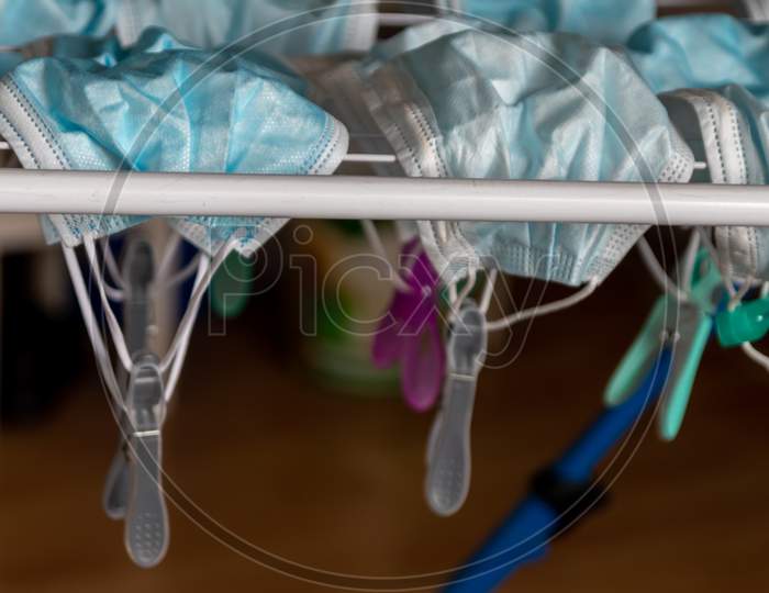 Image of Washed surgical masks hanging on a clothes drying rack after ...