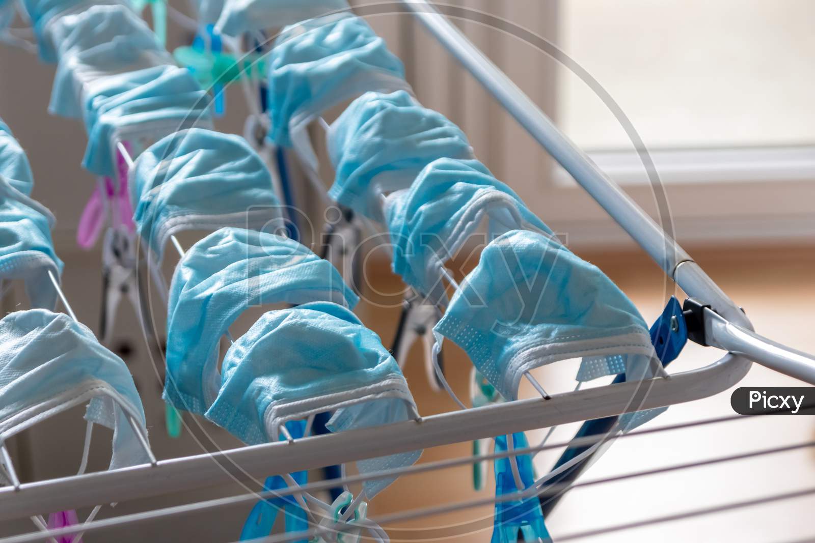 Image of Washed surgical masks hanging on a clothes drying rack after ...