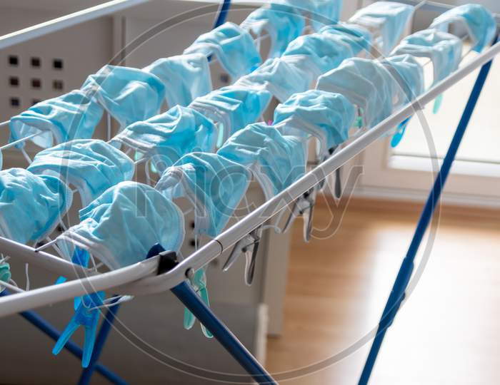 Image of Washed surgical masks hanging on a clothes drying rack after ...