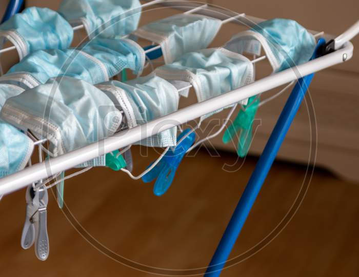 Image of Washed surgical masks hanging on a clothes drying rack after ...