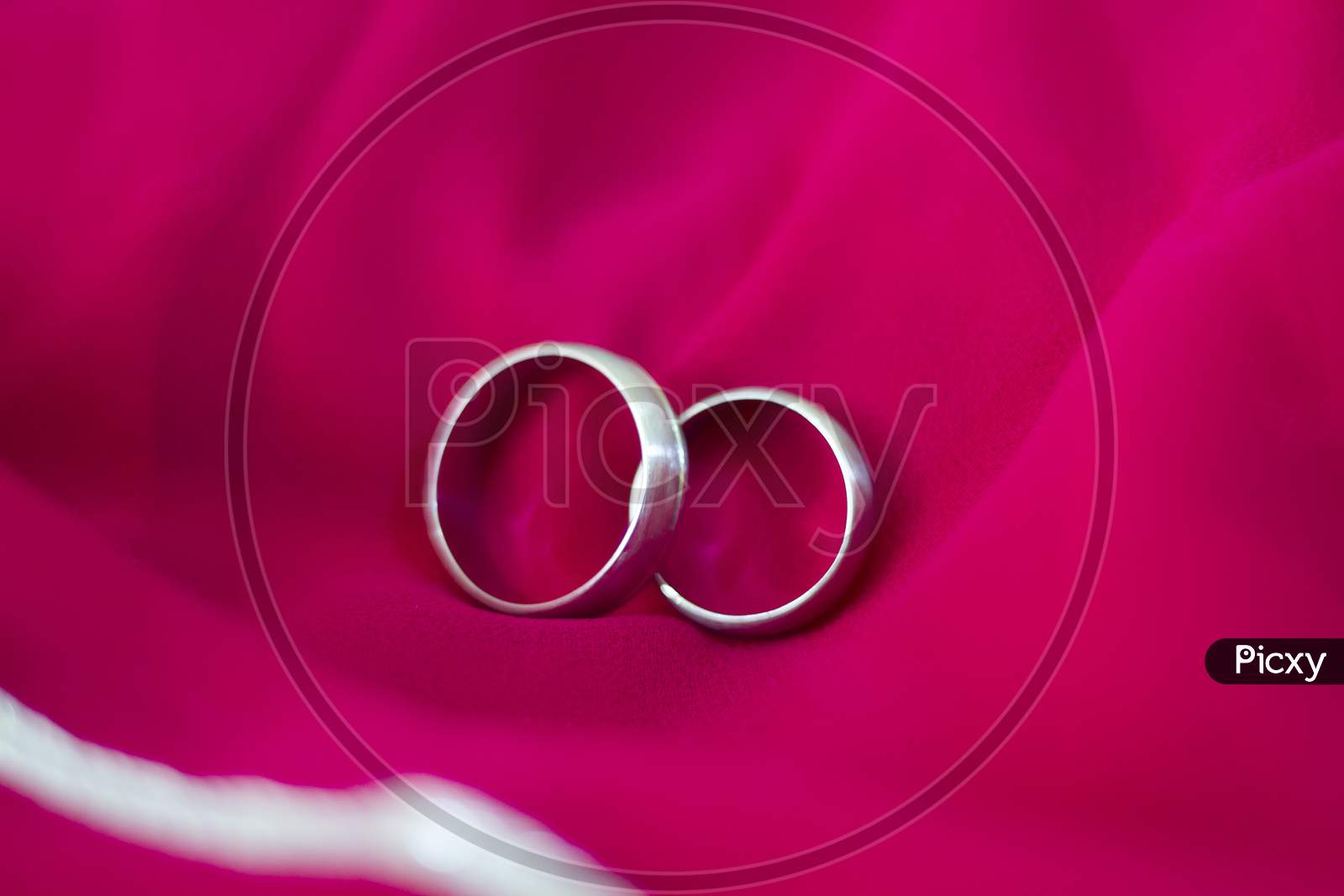 Image of Two Platinum Engagement Or Wedding Rings Isolated On Pink ...
