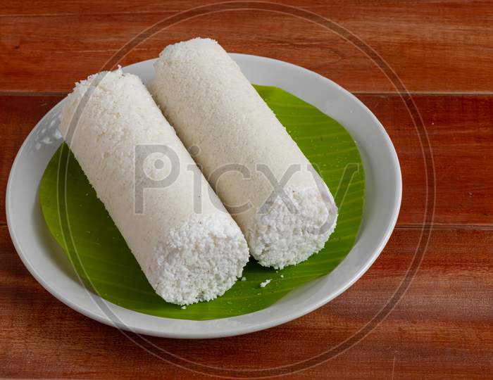 Image of Puttu_White Plate_Wooden Bg-GP299442-Picxy