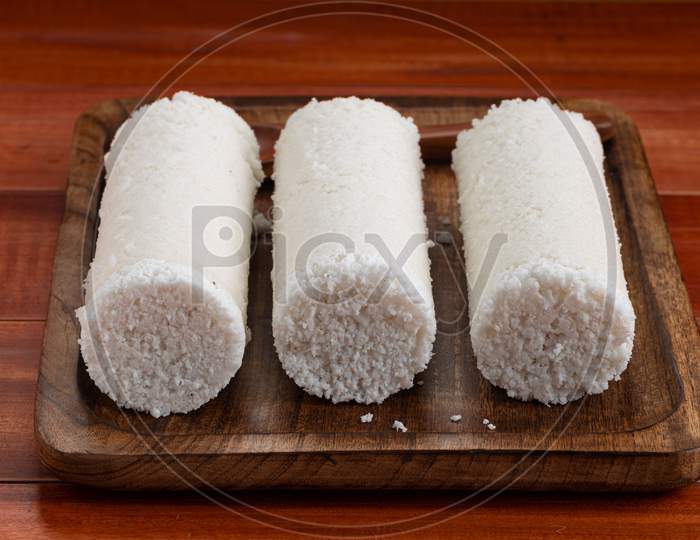 Image of Raw Rice Puttu_Pittu_Pachaarisi Maavu Puttu_Wooden Bg-GT909646 ...