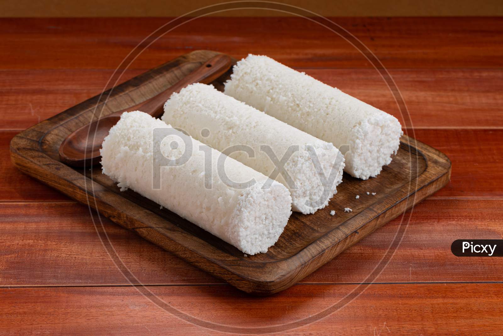 Image of Raw Rice Puttu_Pittu_Pachaarisi Maavu Puttu_Wooden Bg-GT909646 ...