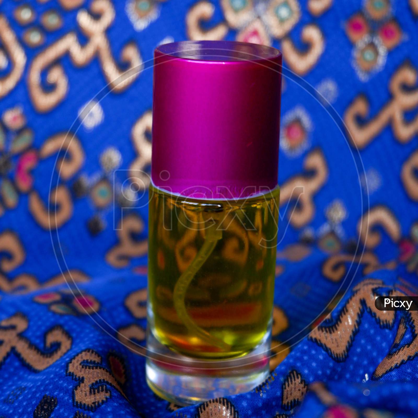 Image of Perfume Bottle With A Yellow Perfume Color On A Blue Batik ...