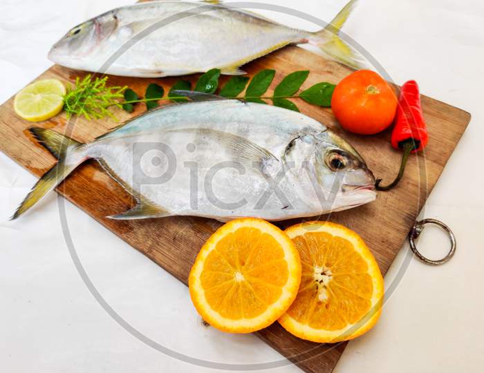 Image of Fresh Malabar Trevally Fish Decorated With Herbs And Fruits On ...