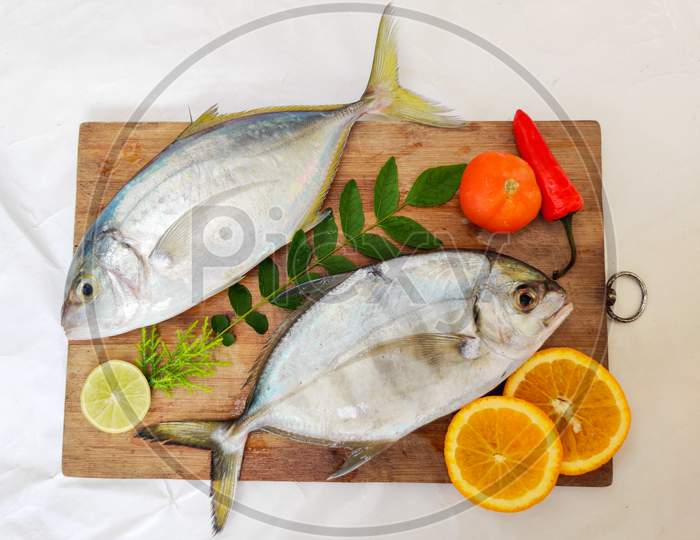 Image of Fresh Malabar Trevally Fish Decorated With Herbs And Fruits On ...