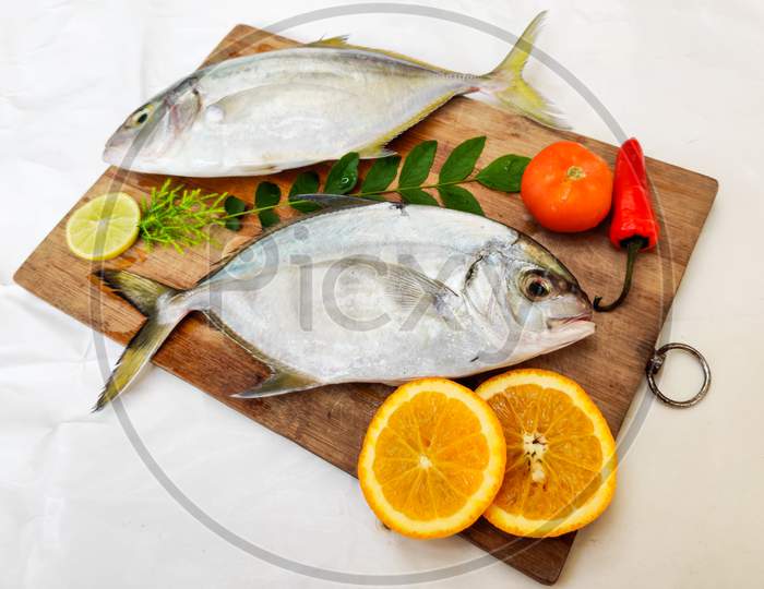 Image of Fresh Malabar Trevally Fish Decorated With Herbs And Fruits On ...