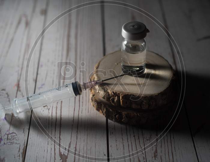 Image of Syringe Pointing Upwards With Glass Vial Filled With Liquid ...